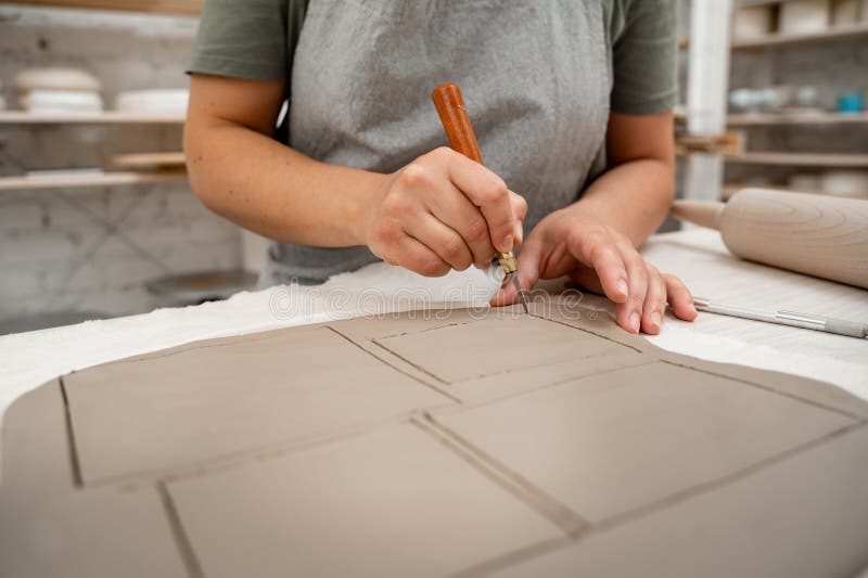 Cutting Out Rectangle Figures Out of a Flat Sheet of Clay with a ...