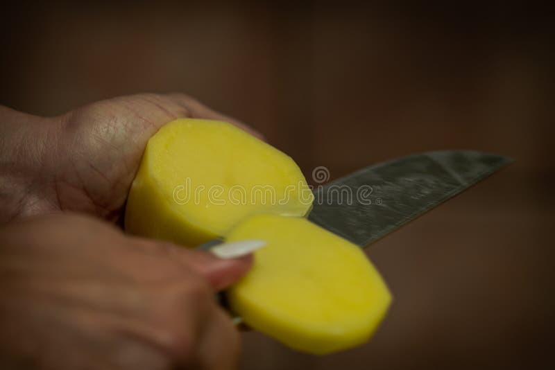 Cutting Potato in Women Hand with Knife Stock Photo - Image of hand ...