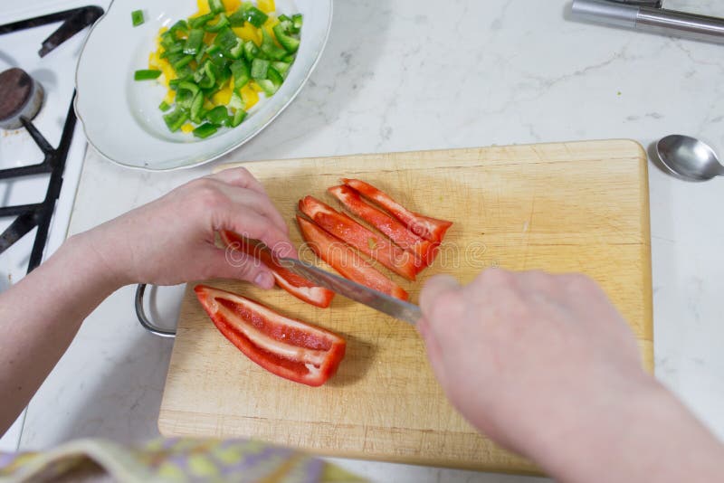 Cutting red peppers. stock image. Image of yellow, white - 31160621