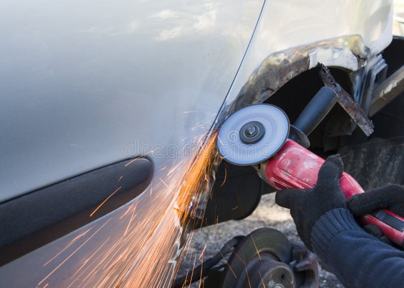 Cutting a Rusty Wheel Arch of a Car with a Grinding Machine, Close-up ...
