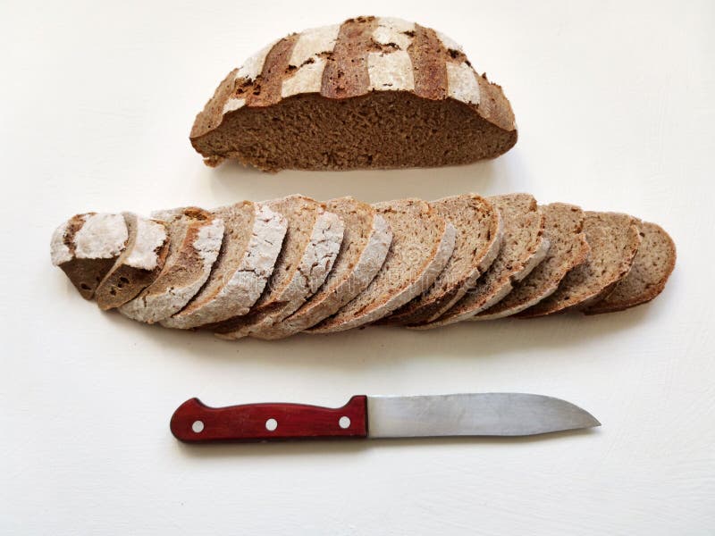 Cutting Rye Bread in a Row and a Knife on a White Background Stock ...