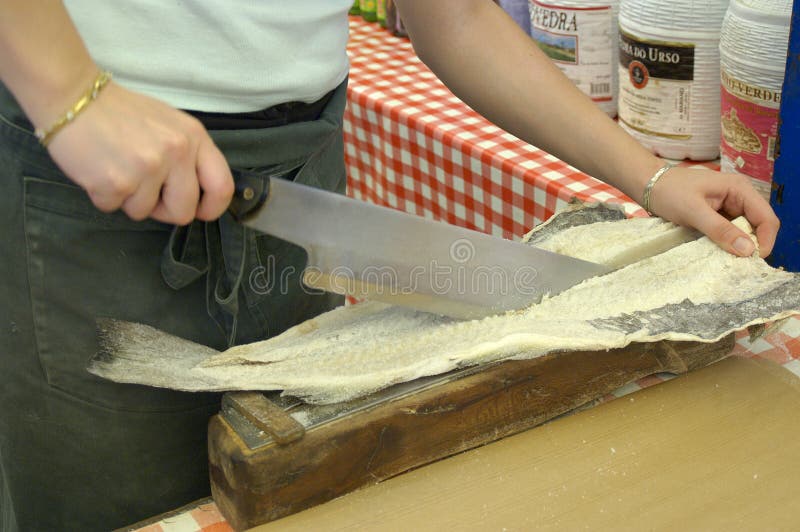 Cutting salt-cod editorial stock image. Image of chopping - 23704574