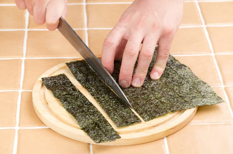 Cutting seaweed for sushi stock image. Image of paper - 48954143