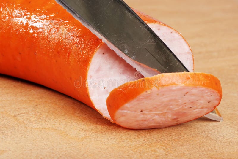 Cutting slice of kielbasa stock photo. Image of product - 13117894