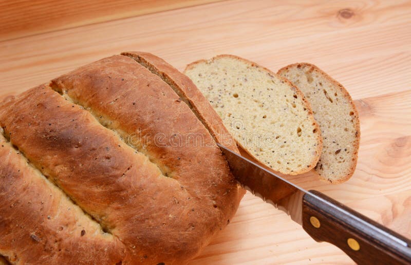 Cutting Slices of Bread on a Wooden Table Stock Image - Image of food ...