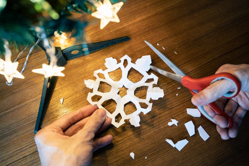 Cutting the Snowflake Shape Out of a Paper Stock Image - Image of ...