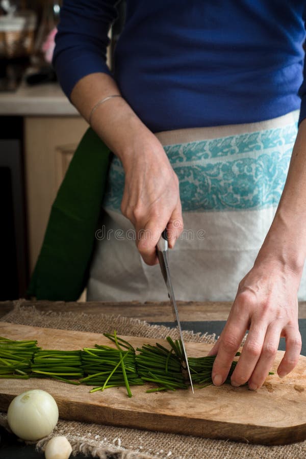 Cutting Spring Onion on the Wooden Board Vertical Stock Photo - Image ...