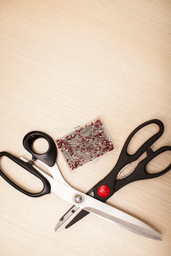 On the Cutting Table Lie Scissors and Pins. Work Place of Seamstress ...
