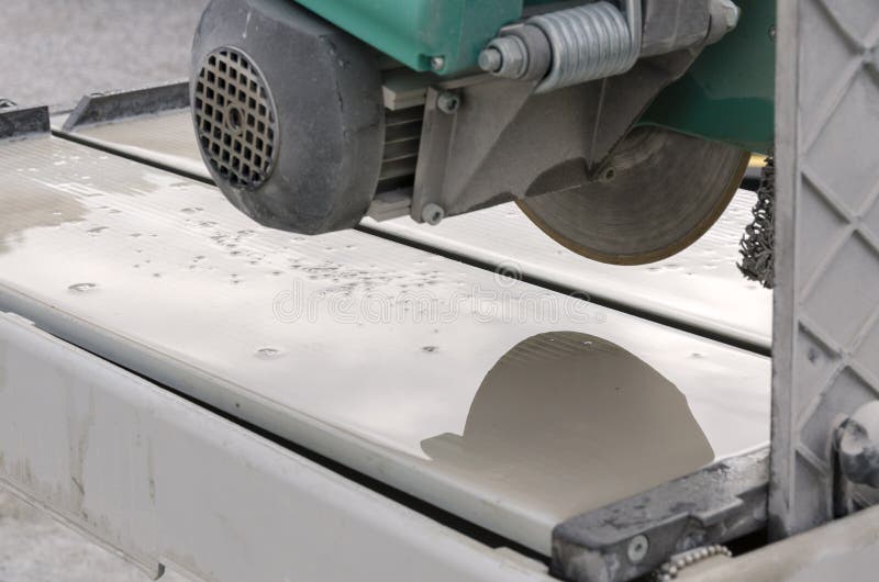 Cutting a tile stock image. Image of cutting, restructuring - 70193253