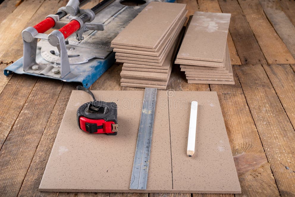 Cutting Tiles in a Home Workshop. Tiling Work on a Workshop Table Stock ...