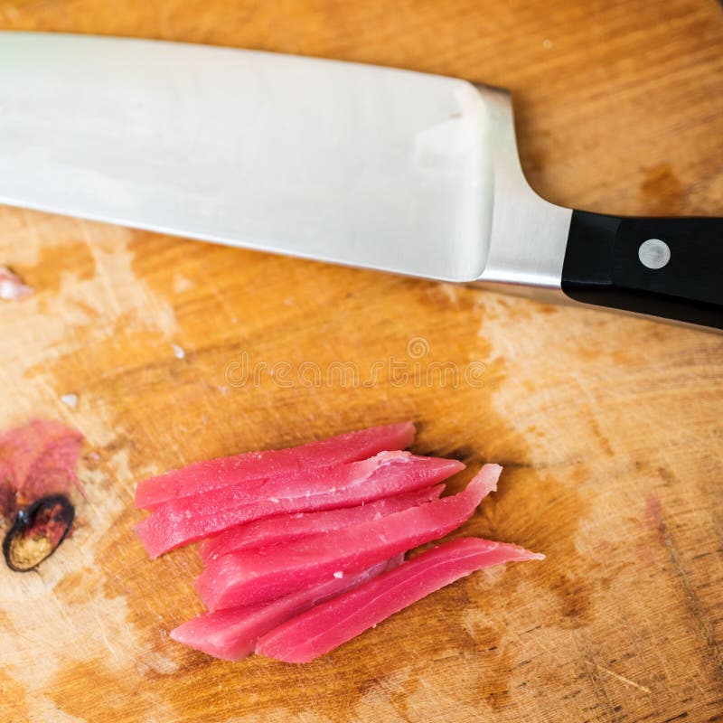 Cutting Tuna Fish in Tiny Pieces Stock Photo - Image of closeup, knive ...