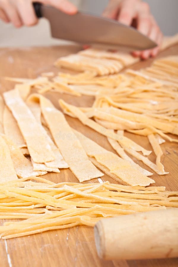 Cutting Uncooked Homemade Egg Pasta Stock Photo - Image of counter ...