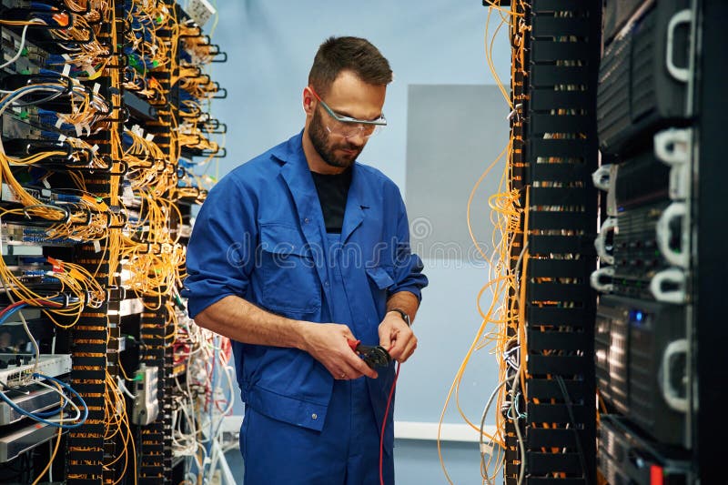 Cutting the Wire. Young Man is Working with Internet Equipment in ...