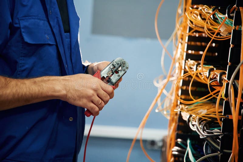 Cutting the Wire. Young Man is Working with Internet Equipment in ...