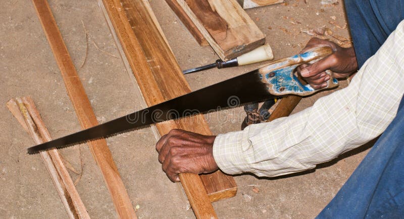 Cutting wood by hand saw stock photo. Image of cutting - 17698120