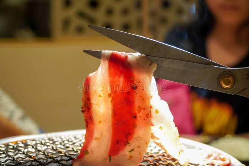 Cutting Yakiniku with Scissors on a Table in a Restaurant Stock Image ...