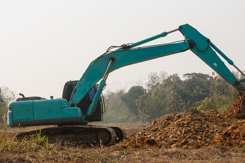 Cyan Excavators are Digging the Soil in the Construction Site Stock ...