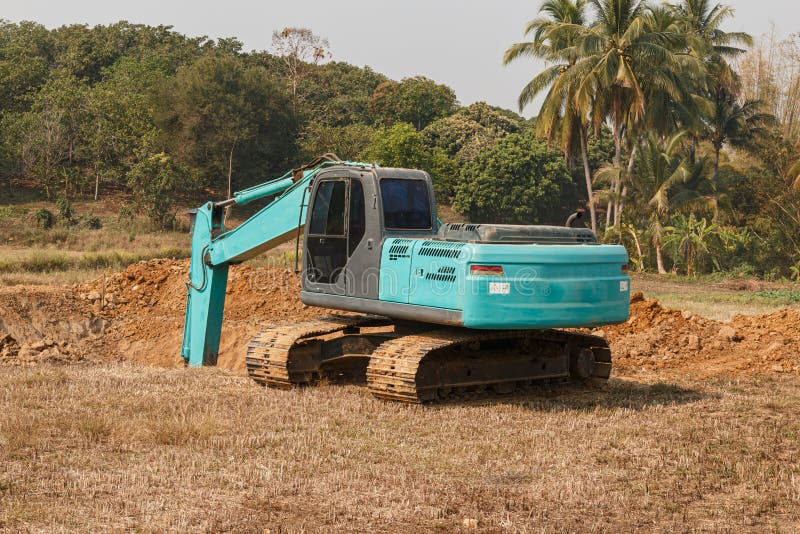 Cyan Excavators are Digging the Soil in the Construction Site. Stock ...