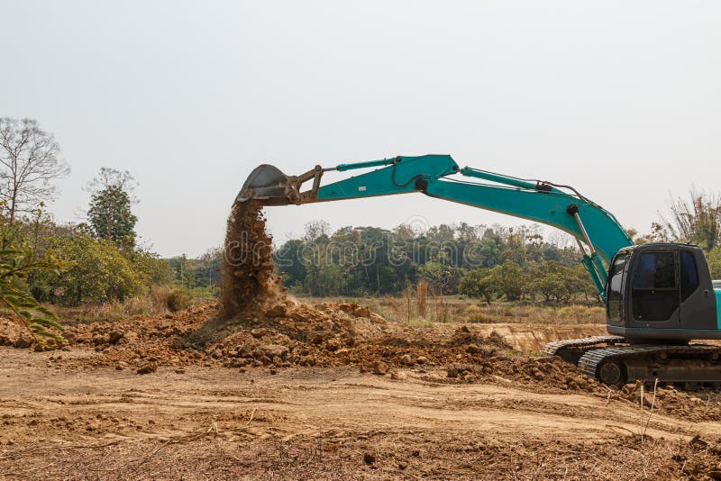 Cyan Excavators are Digging the Soil in the Construction Site. Stock ...