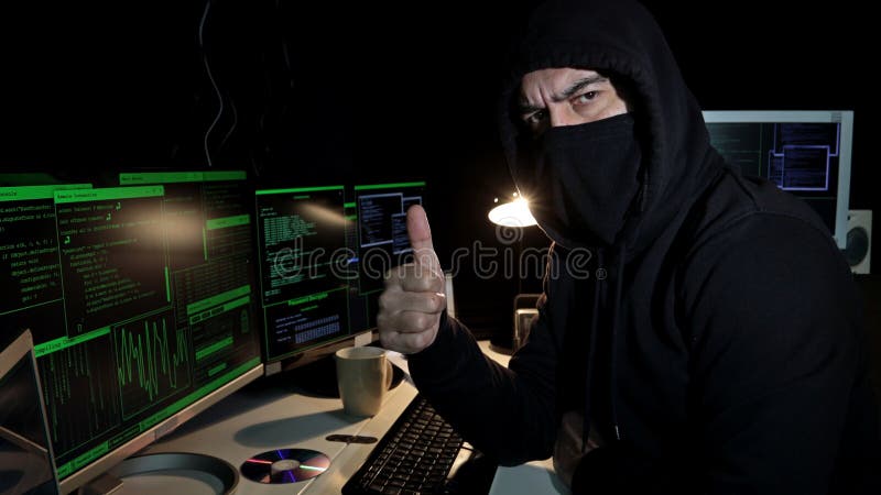 Cyber Hacker with Hood and Covered Face Looks at the Camera Showing ...
