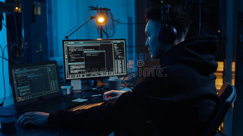 Hacker in Headphones Using Laptop Computer at Night Stock Footage ...