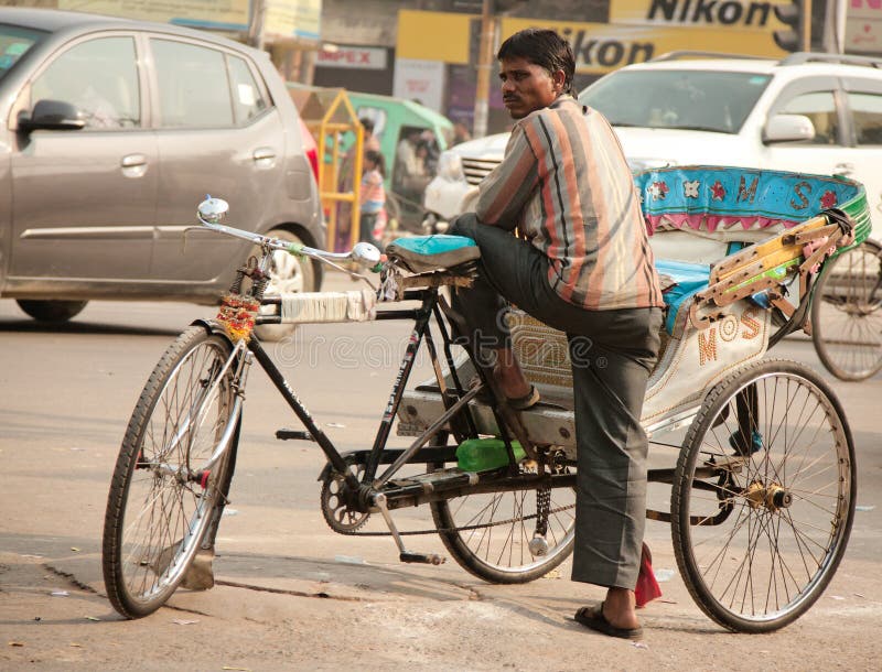 Indian Cycle Rickshaw Driver Sleeps on His Bicycle in Street of New ...