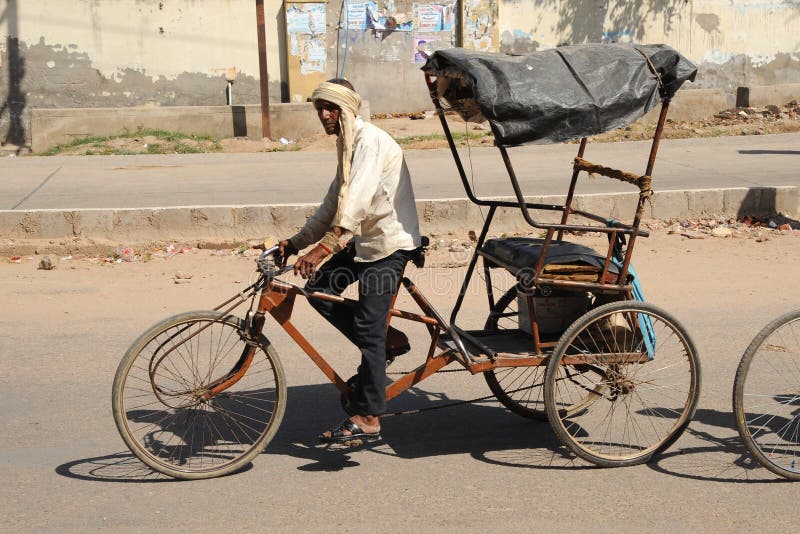 Indian Cycle Rickshaw Driver Sleeps on His Bicycle in Street of New ...