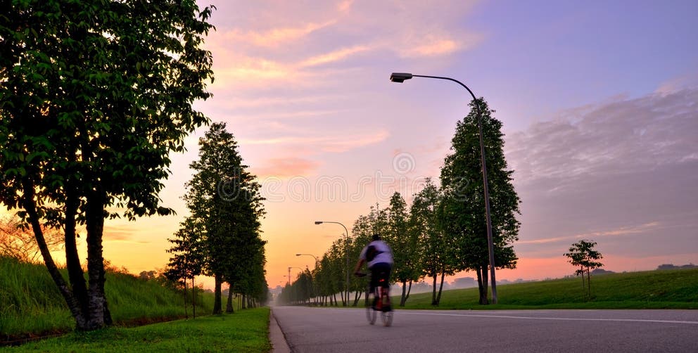 Cycling Alone at Sunrise stock image. Image of road, dawn - 32028985