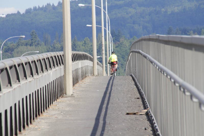 Cycling a Bridge Span stock photo. Image of pedaling - 42009326