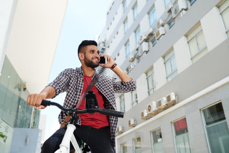 Cycling and calling stock image. Image of gadget, street - 99140541