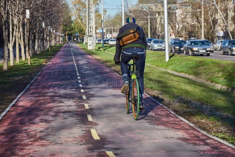 A Cyclist in the City is Moving Along a Bicycle Path. Eco-friendly Mode ...