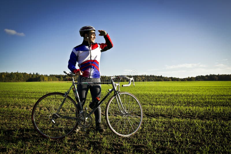 Cyclist in the Field Next To the Bicycle Stock Image - Image of back ...