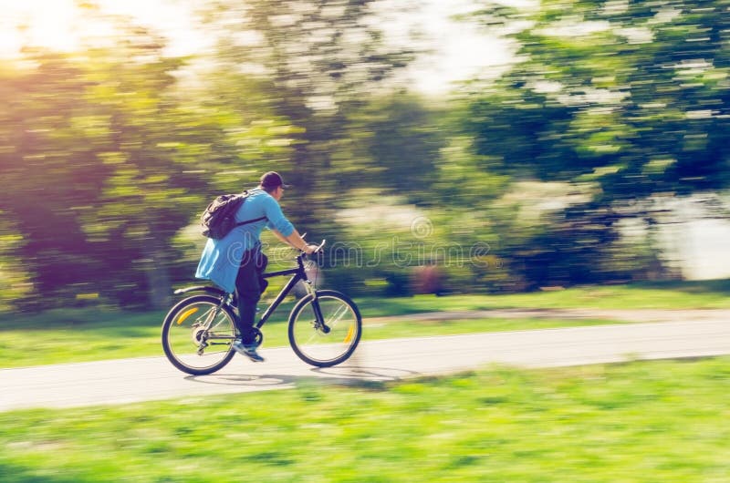 The Cyclist in Motion Riding Bicycle Road, Motion Blur Stock Image ...