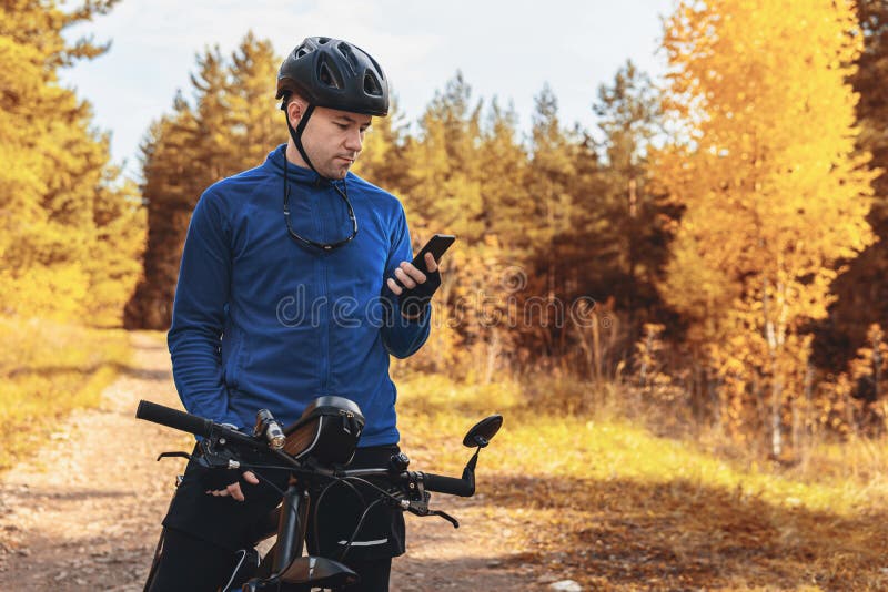 Cyclist on Mountain Bike Using Navigation App on Smartphone, Exploring ...