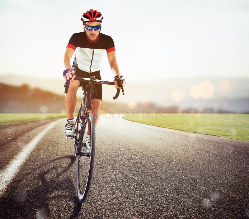 Cyclist Racing on the Road at Sunset Stock Photo - Image of route ...