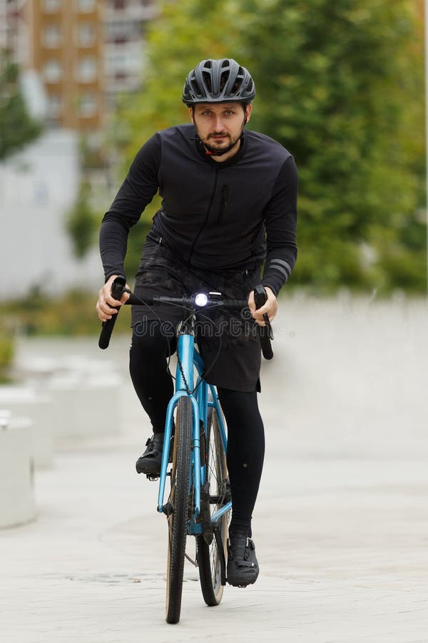 The Cyclist Rides Along the Bike Path, the Route through the City Stock ...