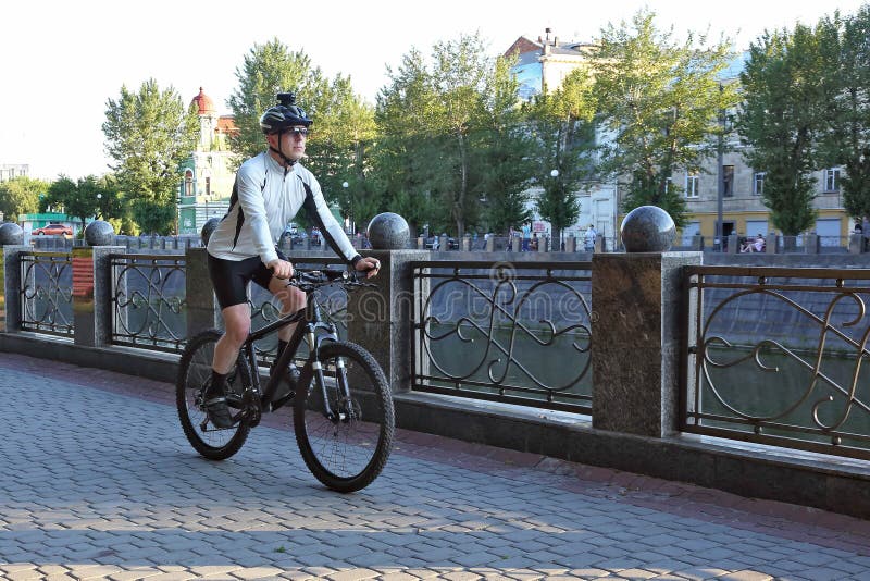 Cyclist Rides a Bicycle on the Pavement Along the Waterfront Stock ...