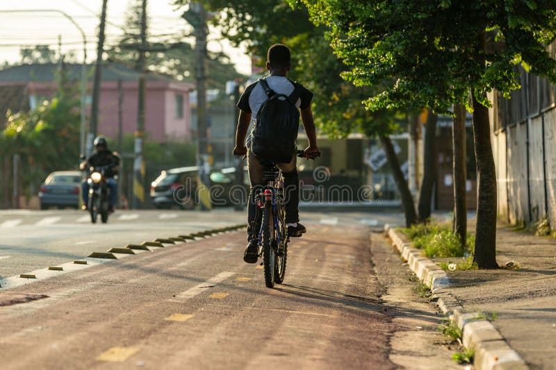 Cyclist Riding a Bicycle on a Cycle Path, in Backlight Editorial ...