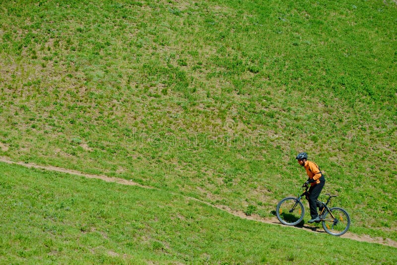 A Cyclist Riding Up A Hill stock photo. Image of cycling - 102843958