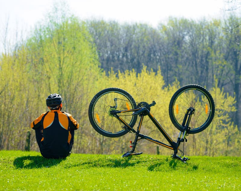 Cyclist Sitting On The Grass Near His Bike Picture. Image: 30775968