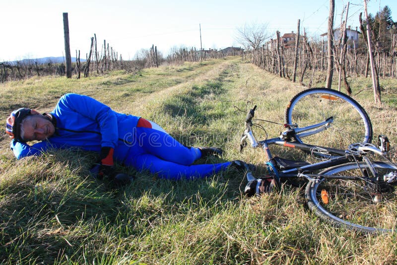 Cyclist Waiting for Help Lying on the Ground Stock Image - Image of ...