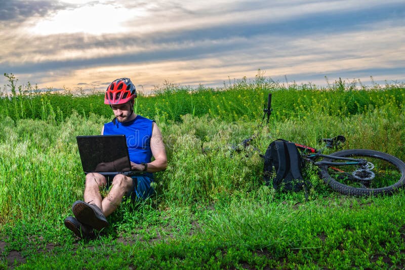 Cyclist Working on a Laptop while Cycling. Remote Work Outdoors Stock ...