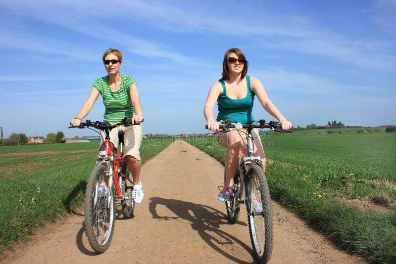 Cyclists side-by-side stock photo. Image of attractive - 19156320