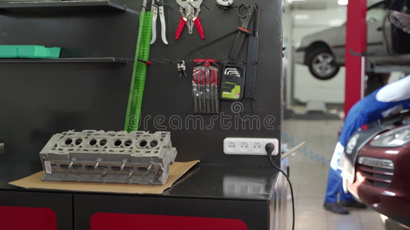 Auto Mechanic Performs Engine Overhaul in Workshop. Cylinder Head on ...