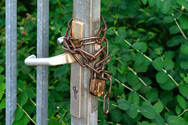Cylinder Lock on a Metal Gate Wrapped in a Rusty Chain with a Padlock ...