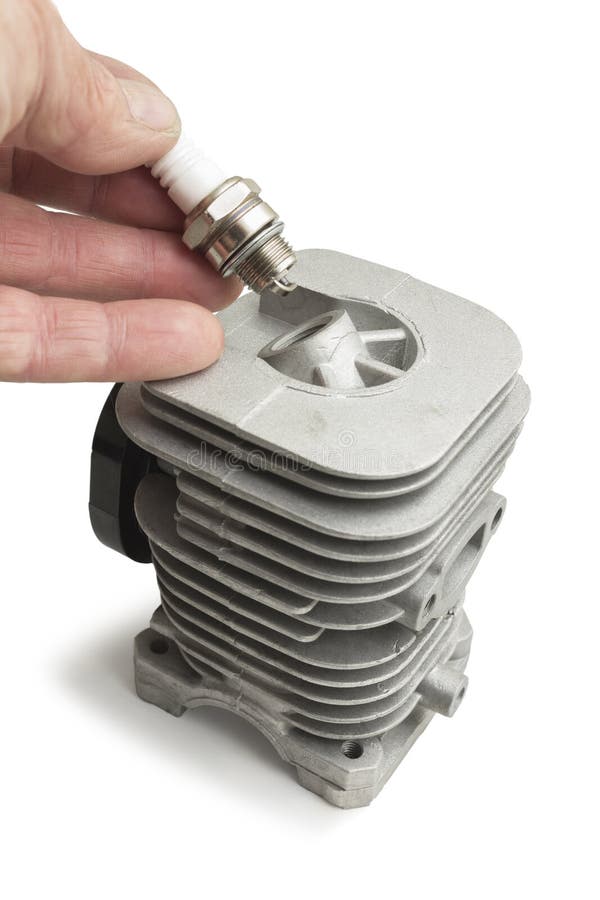A Cylinder for a Two-stroke Engine and a Spark Plug in the Hand of a ...