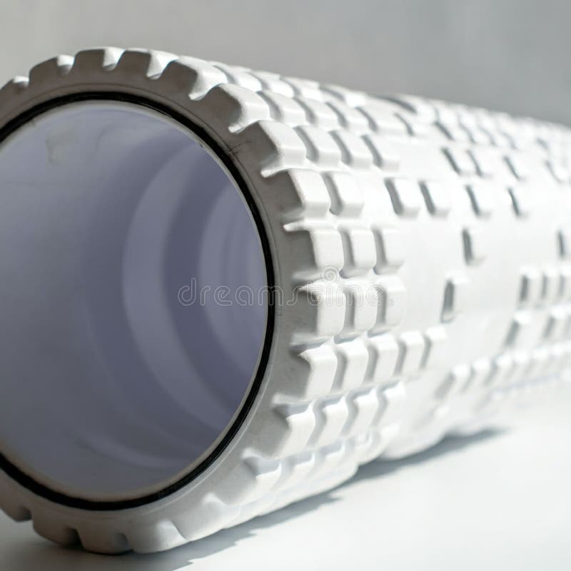 A Cylindrical, White Foam Roller with a Textured Surface Featuring ...