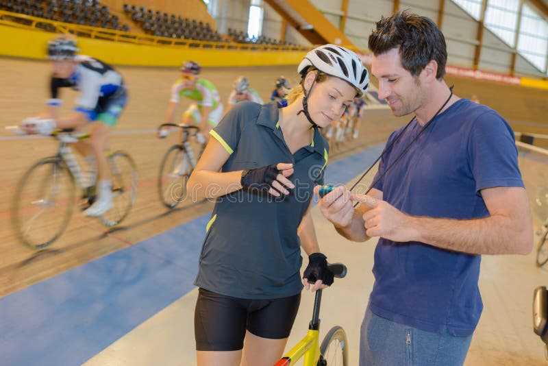 Cylist Looking at Coachs Stopwatch As Others Cycle Past Stock Photo ...