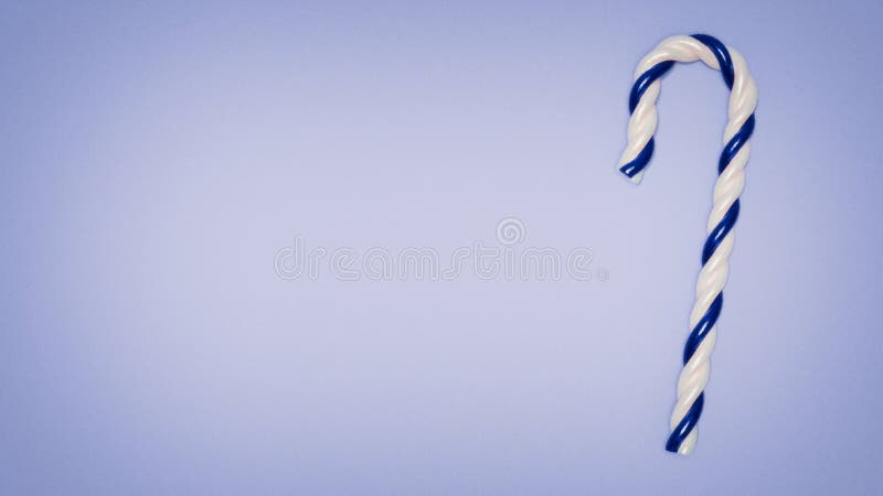 3D Illustration. Blue and White Candy Stick on a Pale Blue Background ...