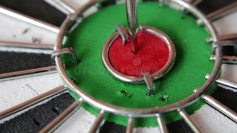 Green Dart Arrow Hitting in the Target Center of Dartboard with Post ...